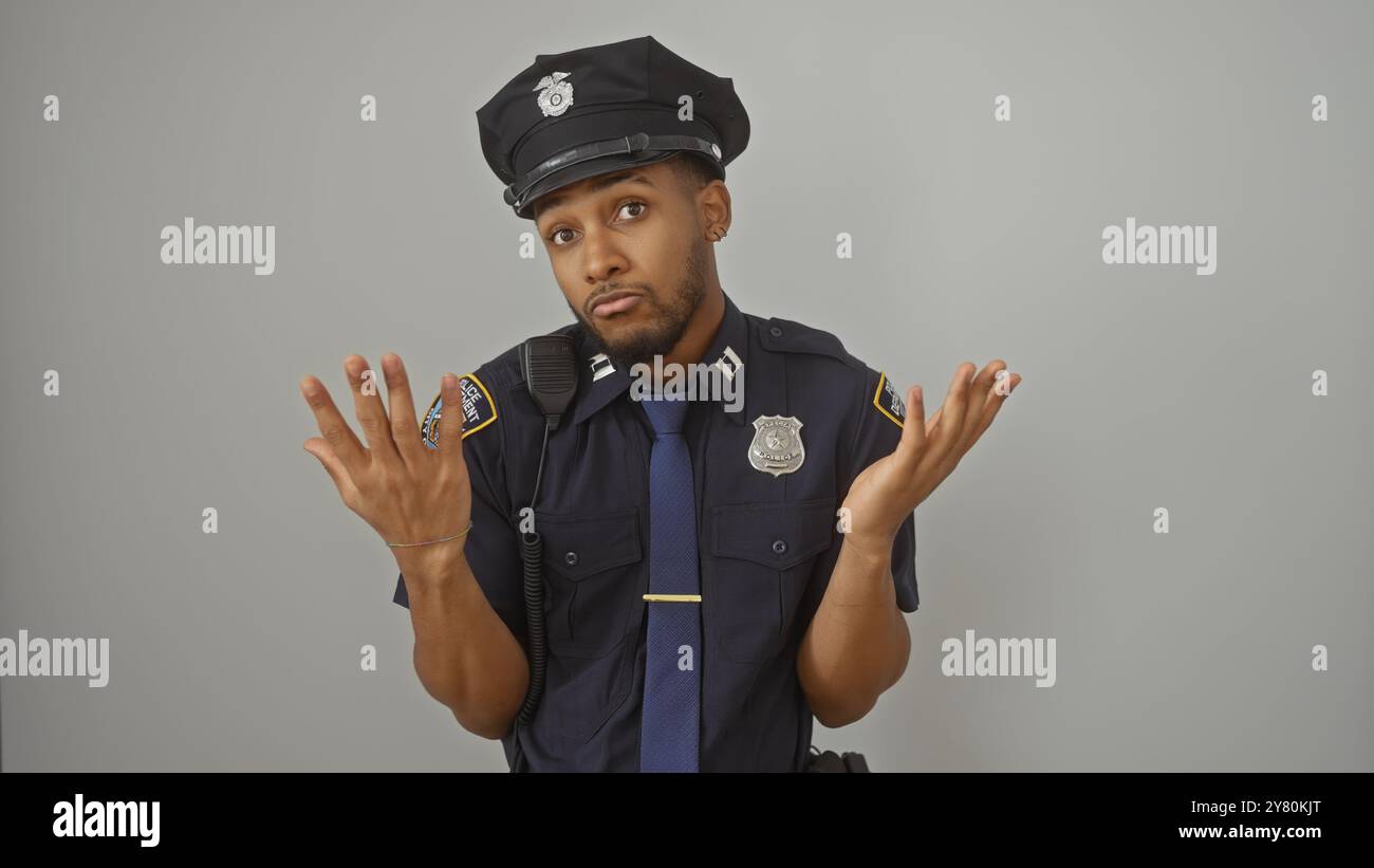 Confused african american male police officer shrugging in uniform ...