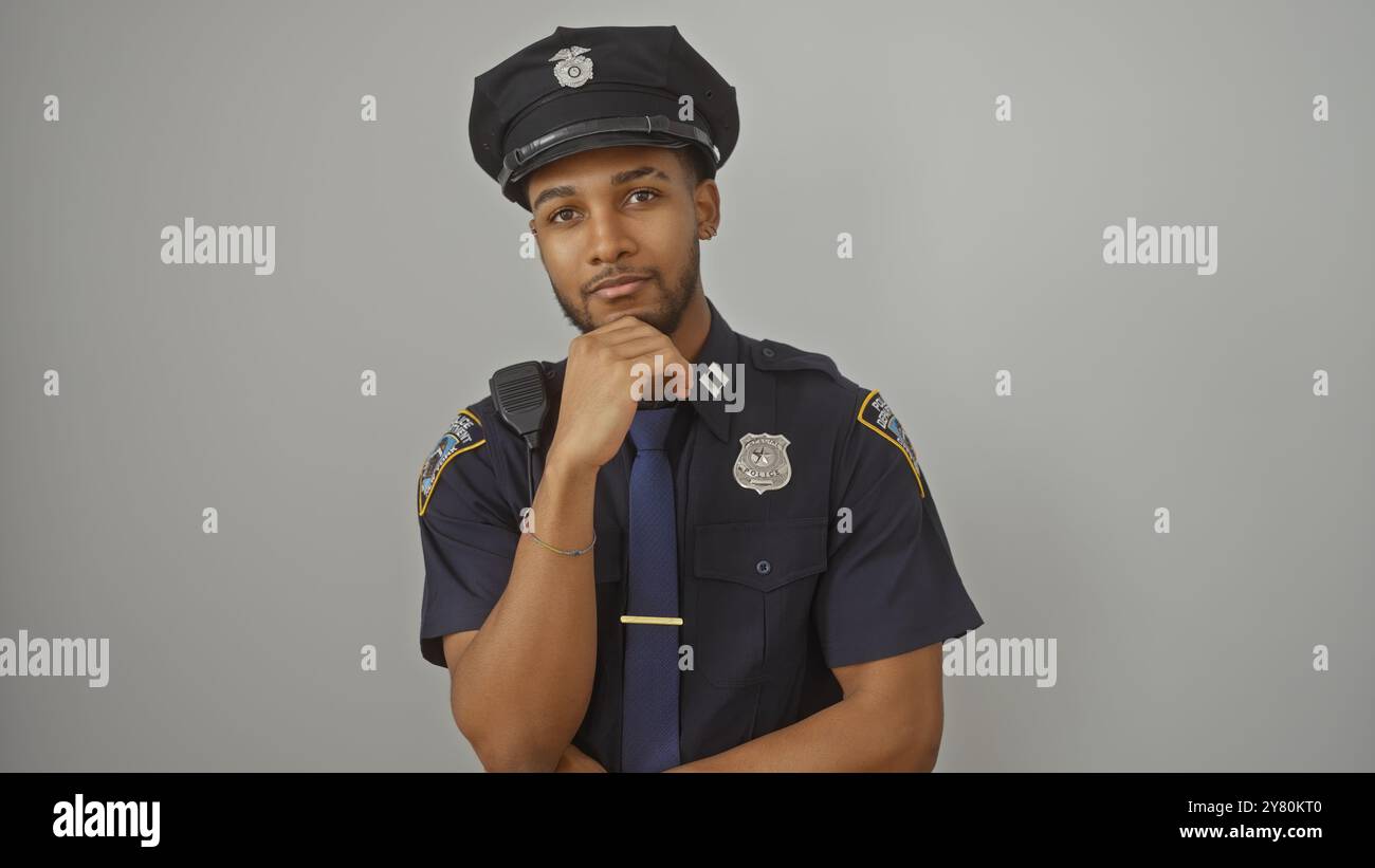 Handsome african american police officer pondering against a white ...