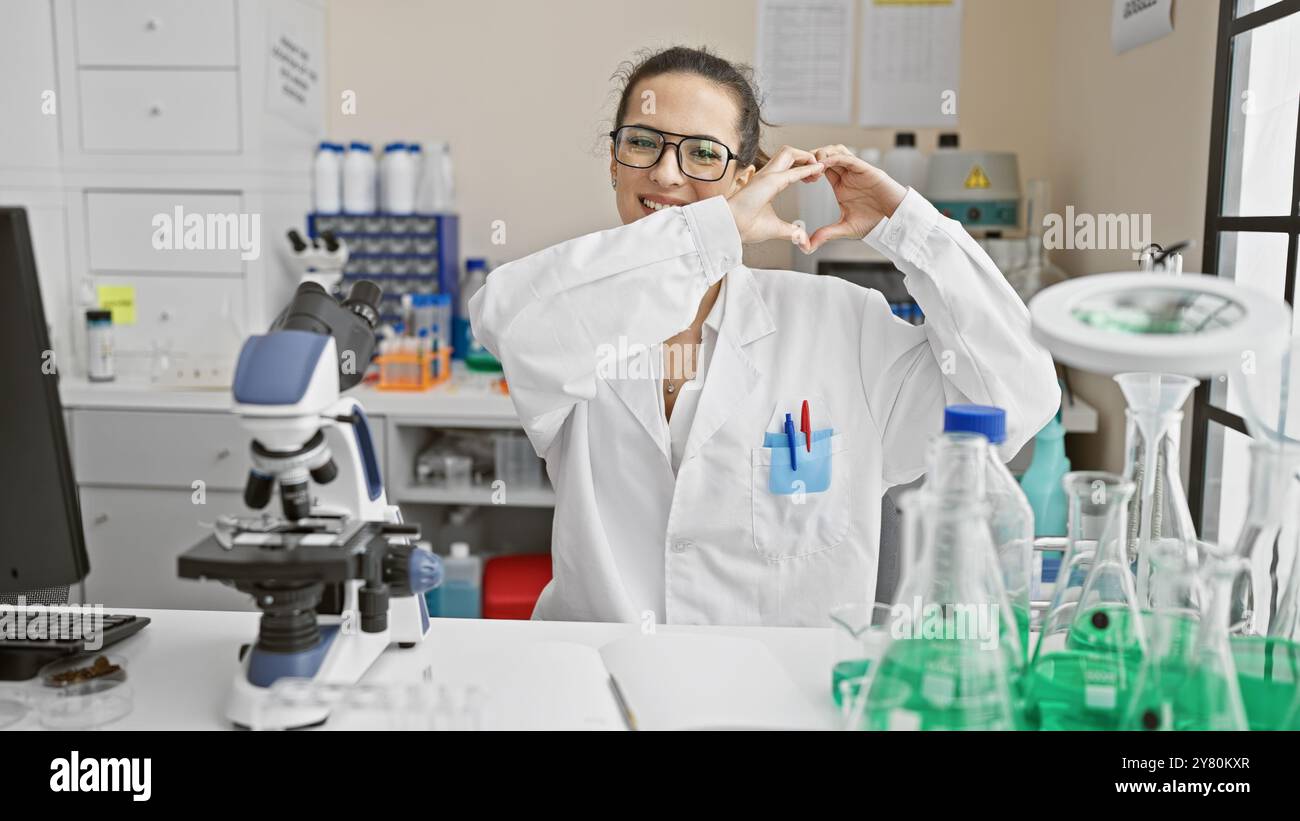 Young hispanic woman in labcoat hi-res stock photography and images - Alamy