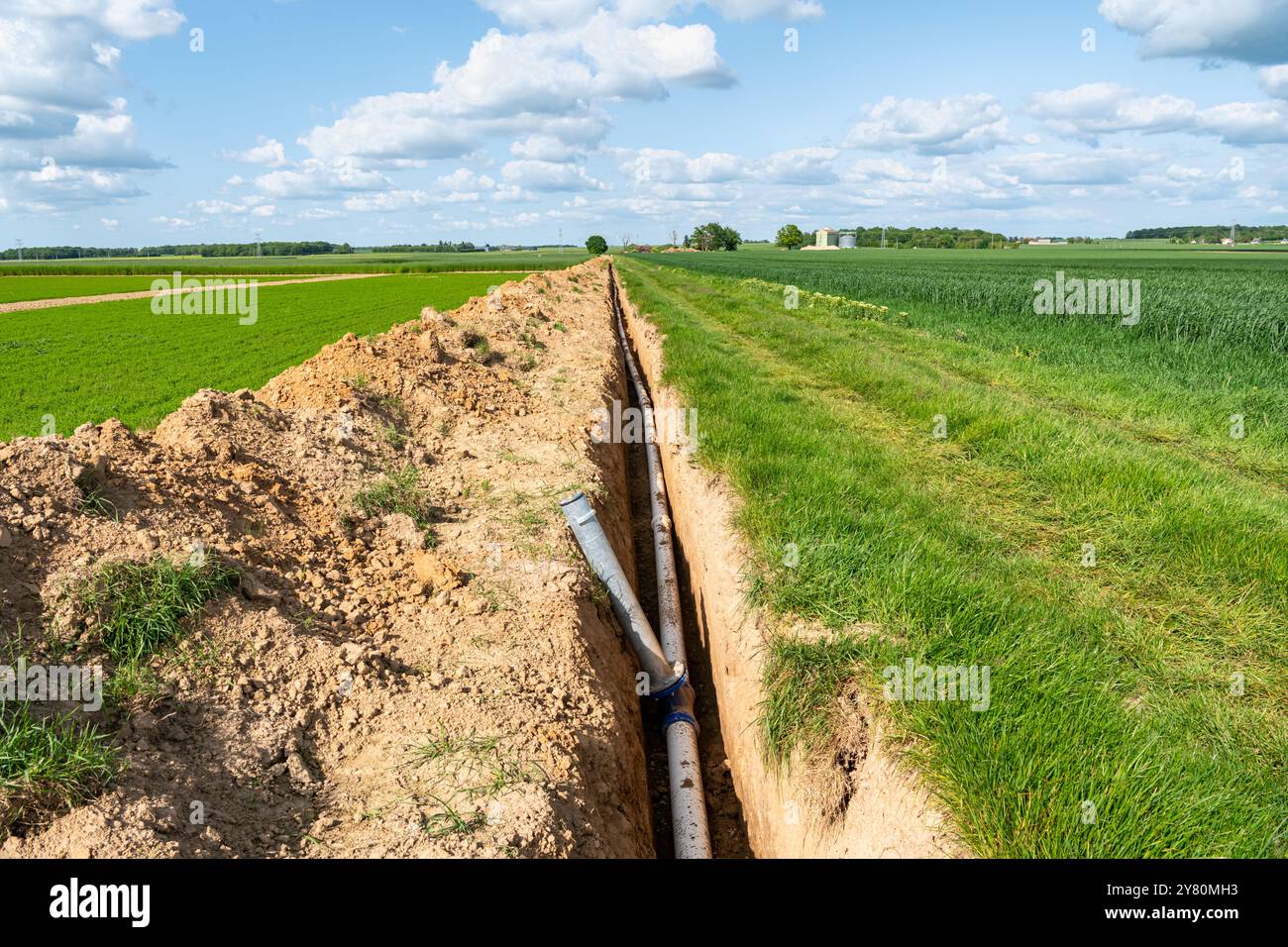 Installation of irrigation pipes, farm irrigation system. Buried pipes ...