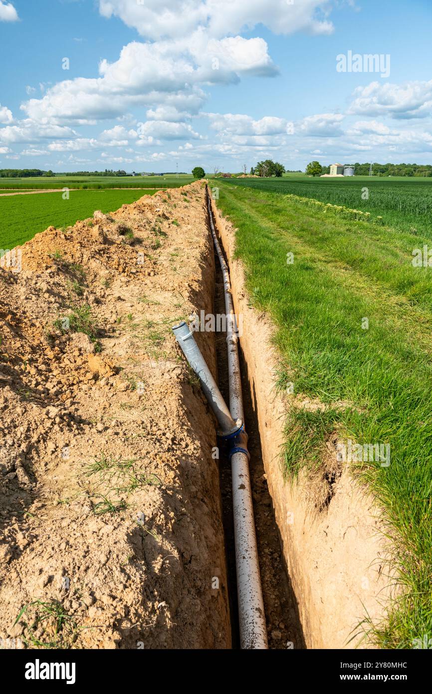 Installation of irrigation pipes, farm irrigation system. Buried pipes ...