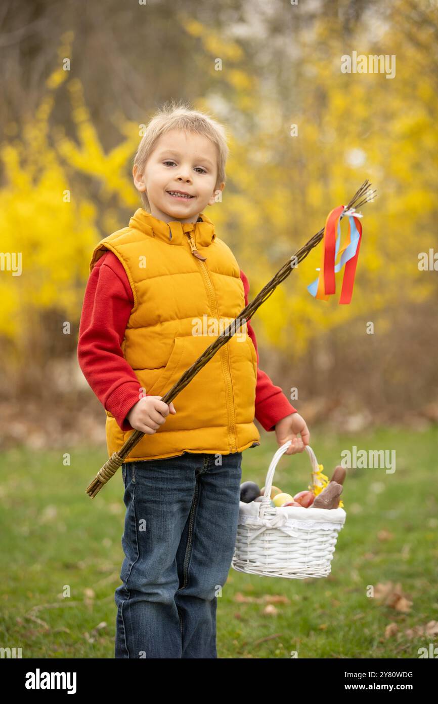 Cute preschool child, boy, holding handmade braided whip made from ...