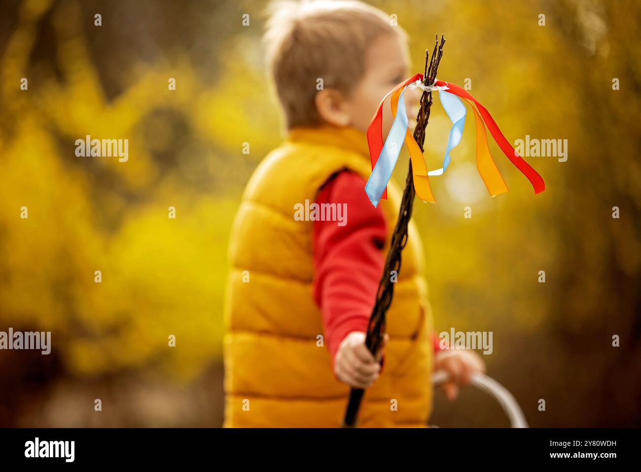 Cute preschool child, boy, holding handmade braided whip made from ...
