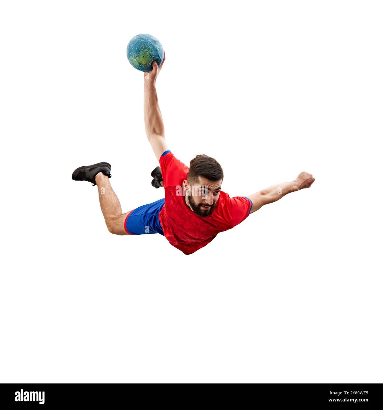 Focused and competitive young man, handball player in motion with ball ...