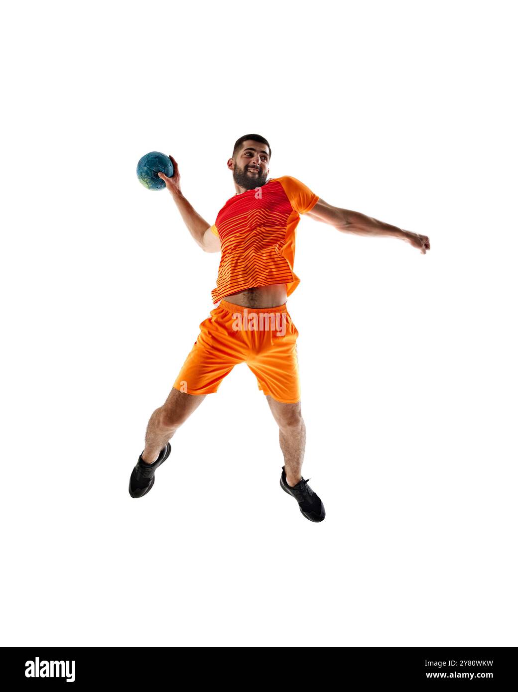 Powerful determined man, handball athlete in orange uniform in motion ...