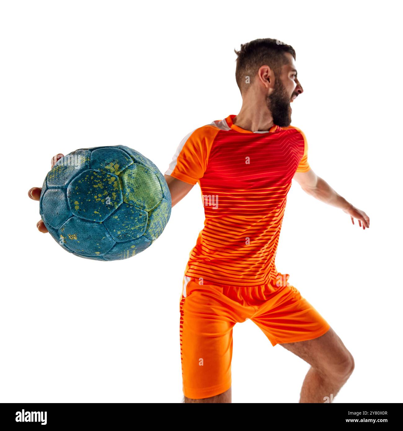 Dynamic image of young bearded man in orange uniform, handball player ...