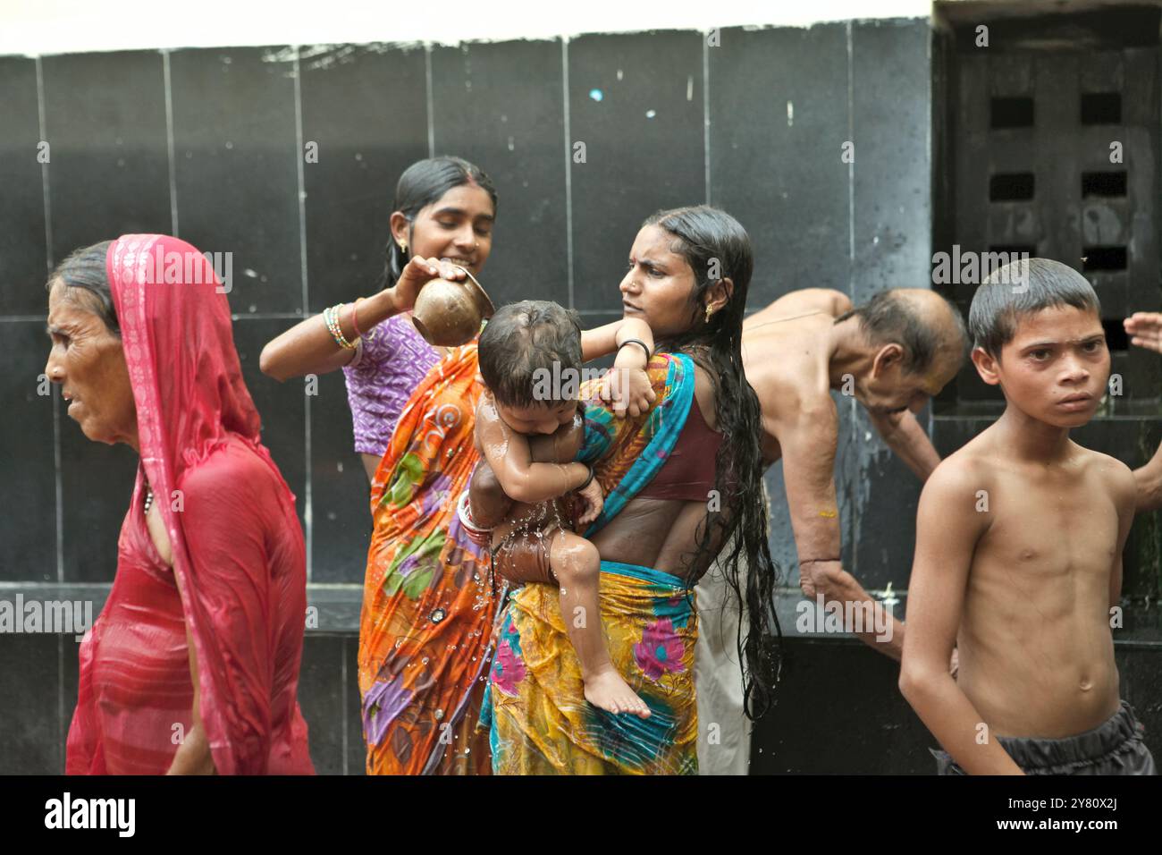 People taking a bath at a hot spring, which is believed to have ...