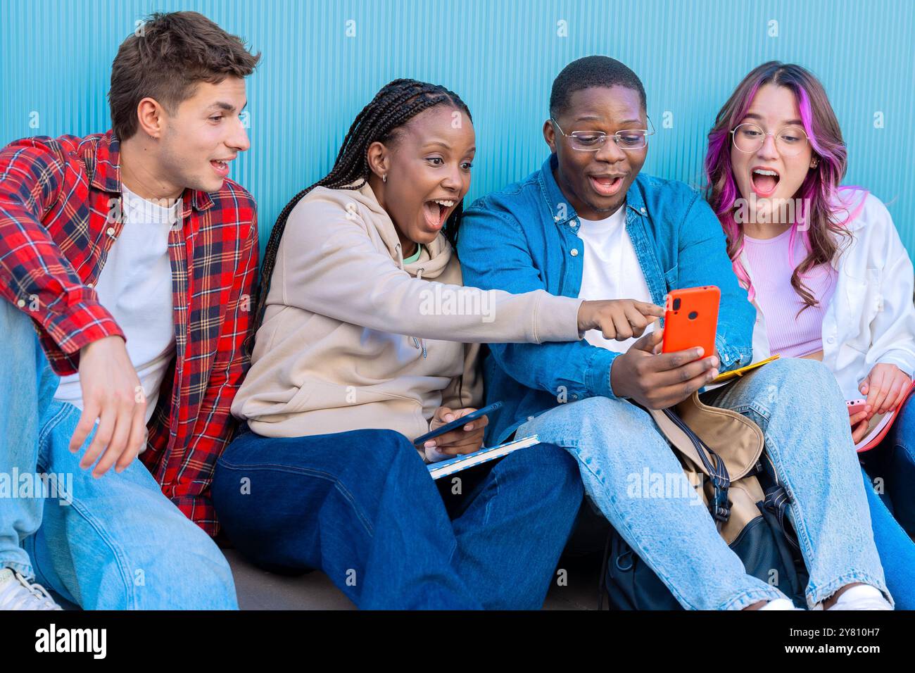 Teens using smartphones outdoors hi-res stock photography and images ...