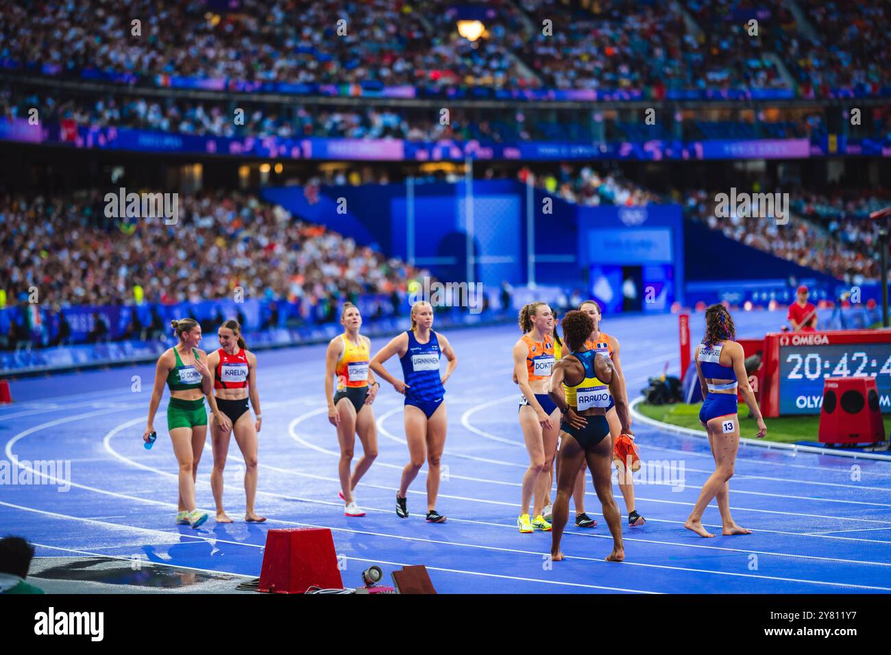 Heptathlon girls waving in the stadium after finishing all the events ...