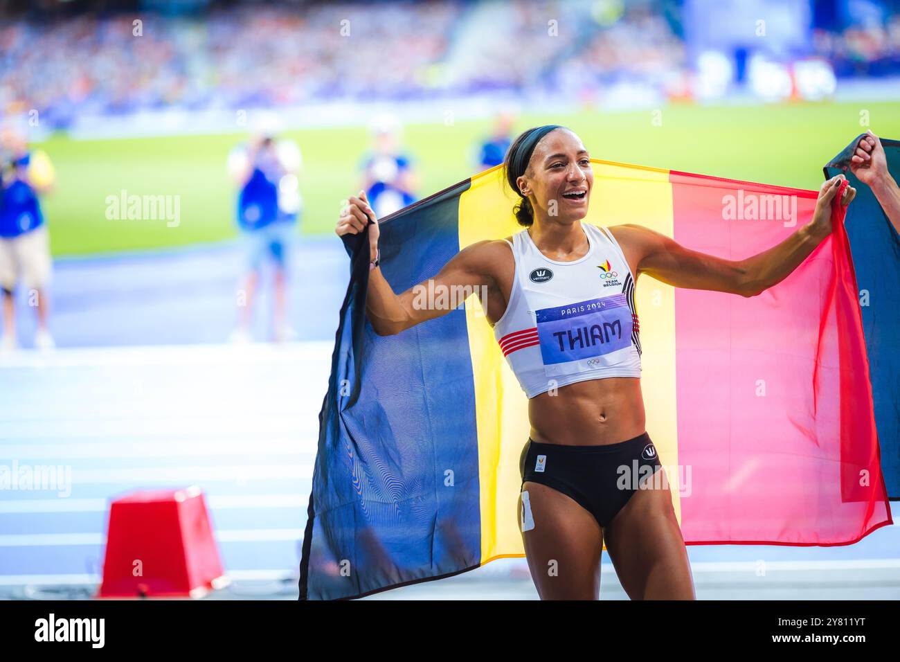Nafissatou Thiam celebrating her victory with her country's flag in the ...