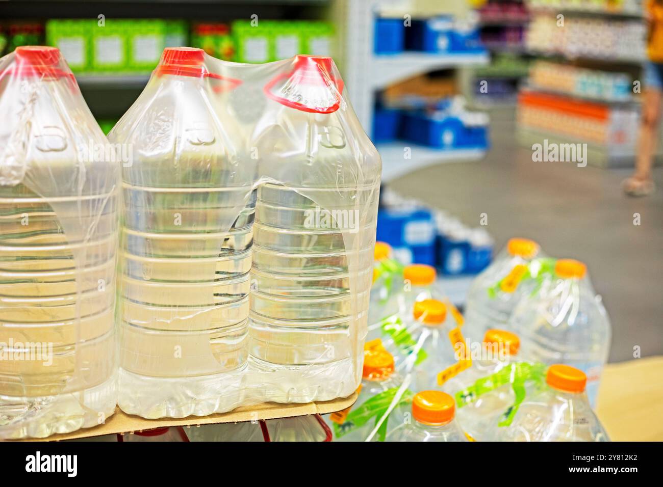 drinking water in different plastic containers in the supermarket ...