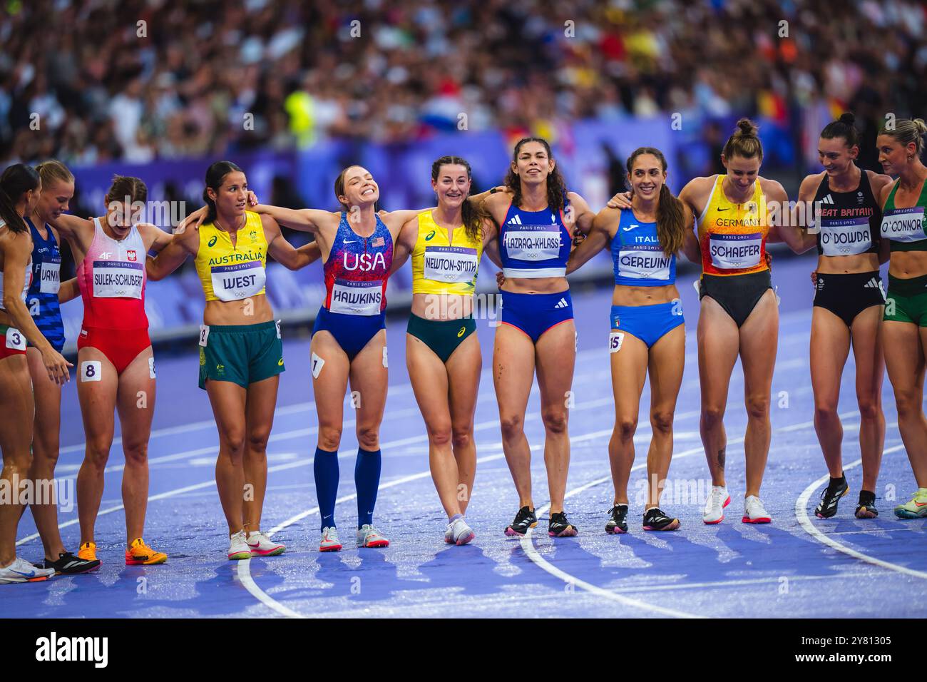 Heptathlon girls waving in the stadium after finishing all the events ...