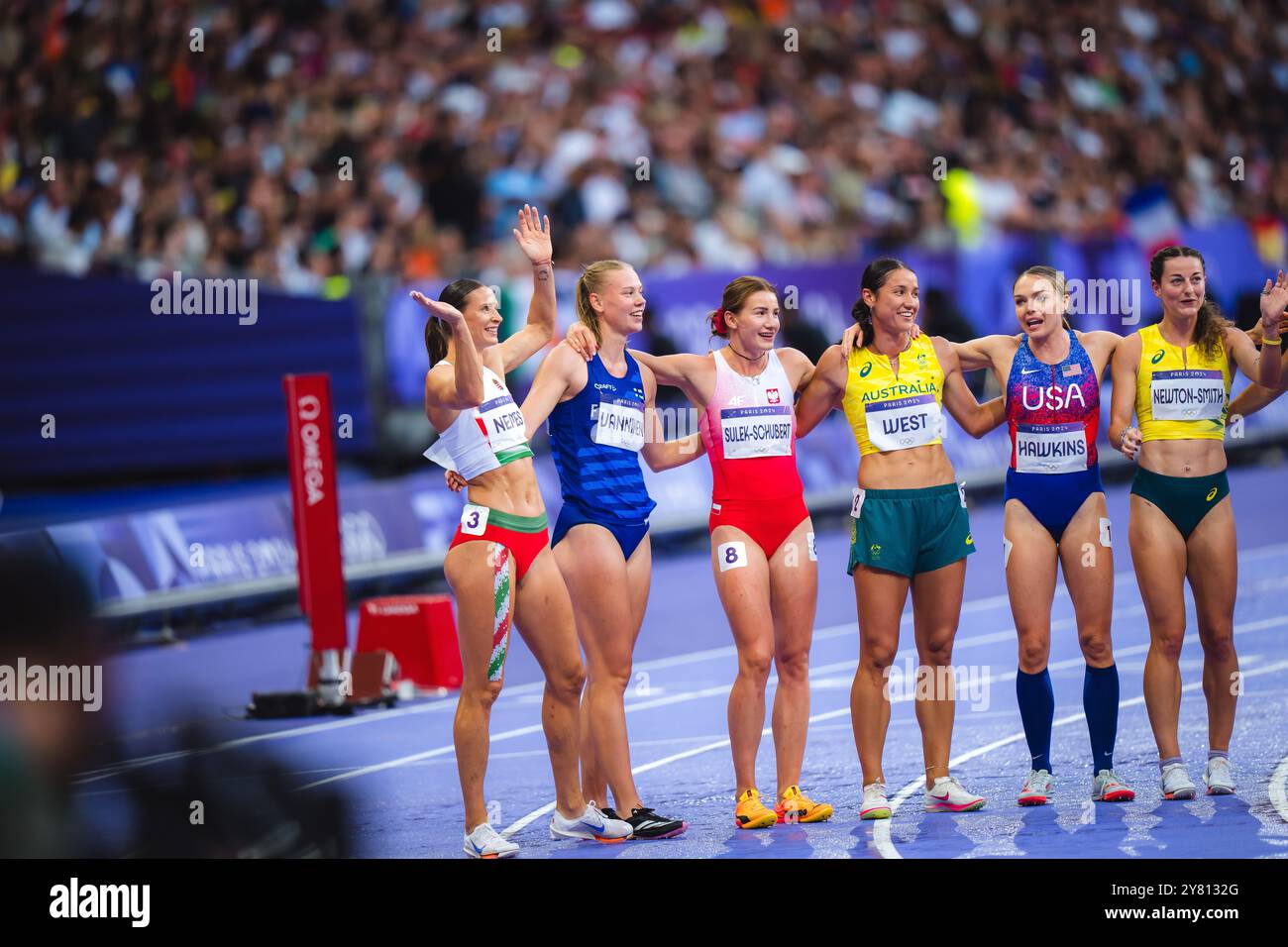 Heptathlon girls waving in the stadium after finishing all the events ...