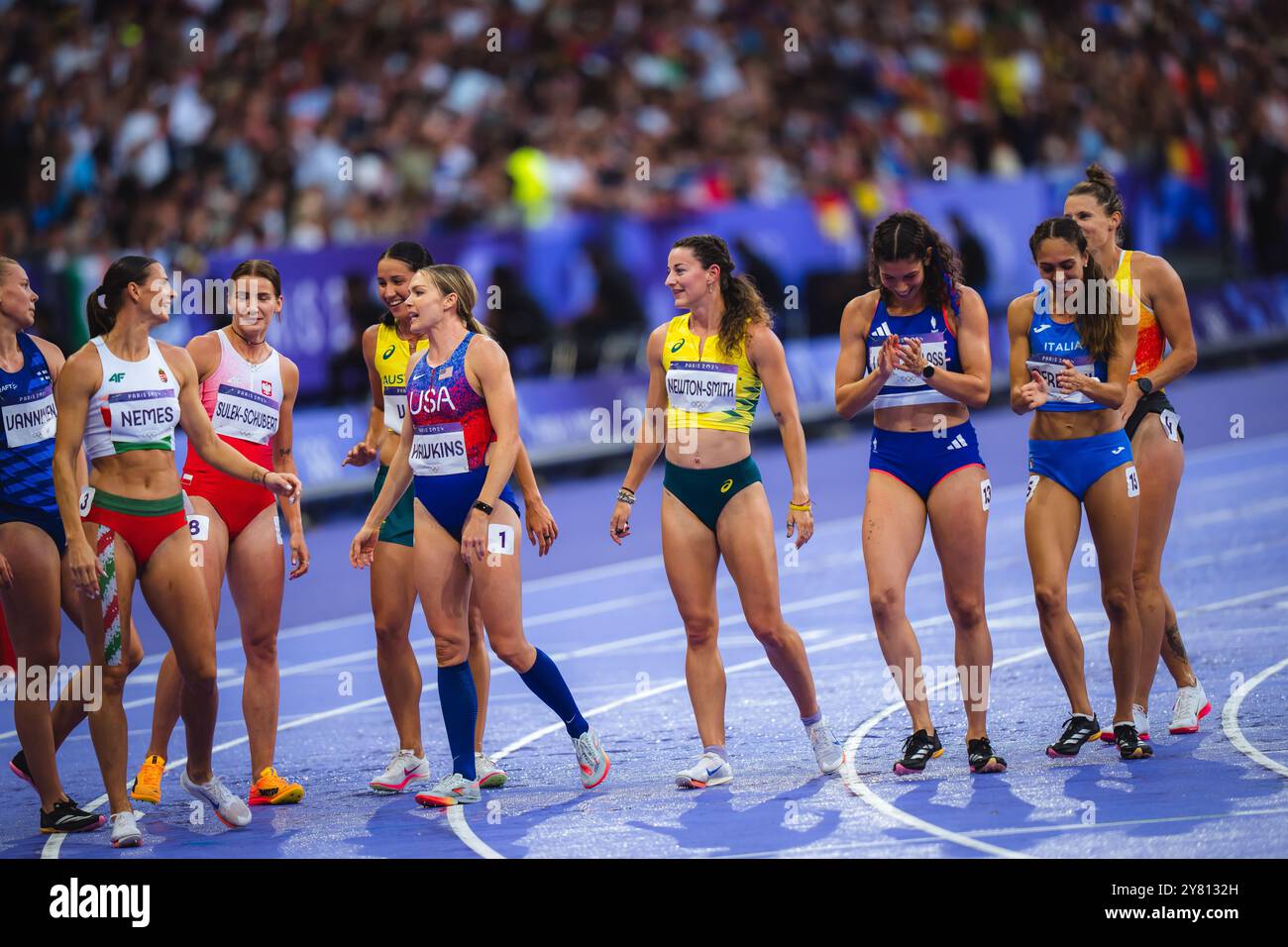 Heptathlon girls waving in the stadium after finishing all the events ...
