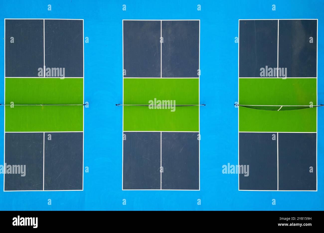 Aerial view of vibrant pickleball courts with distinct green and blue ...