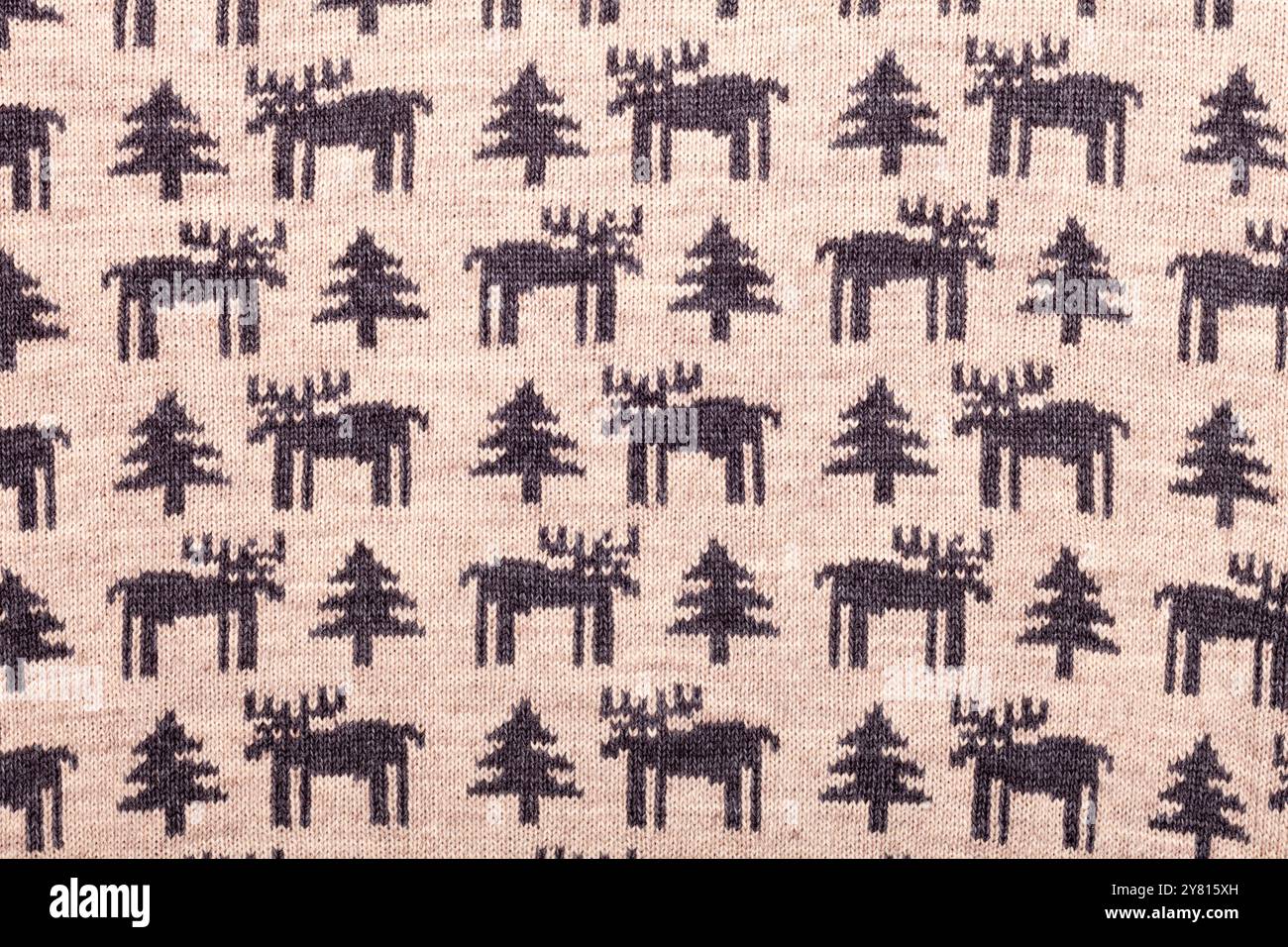 Close-up of knitted fabric showing a repeating pattern of moose and ...
