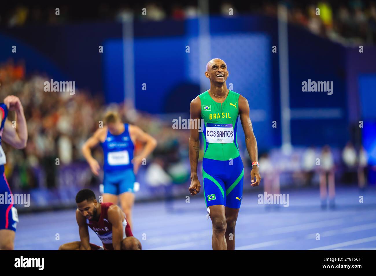 Alison dos Santos celebrating with her country's flag in the 400 meters ...