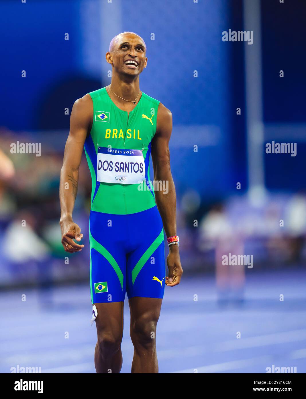 Alison dos Santos celebrating with her country's flag in the 400 meters ...