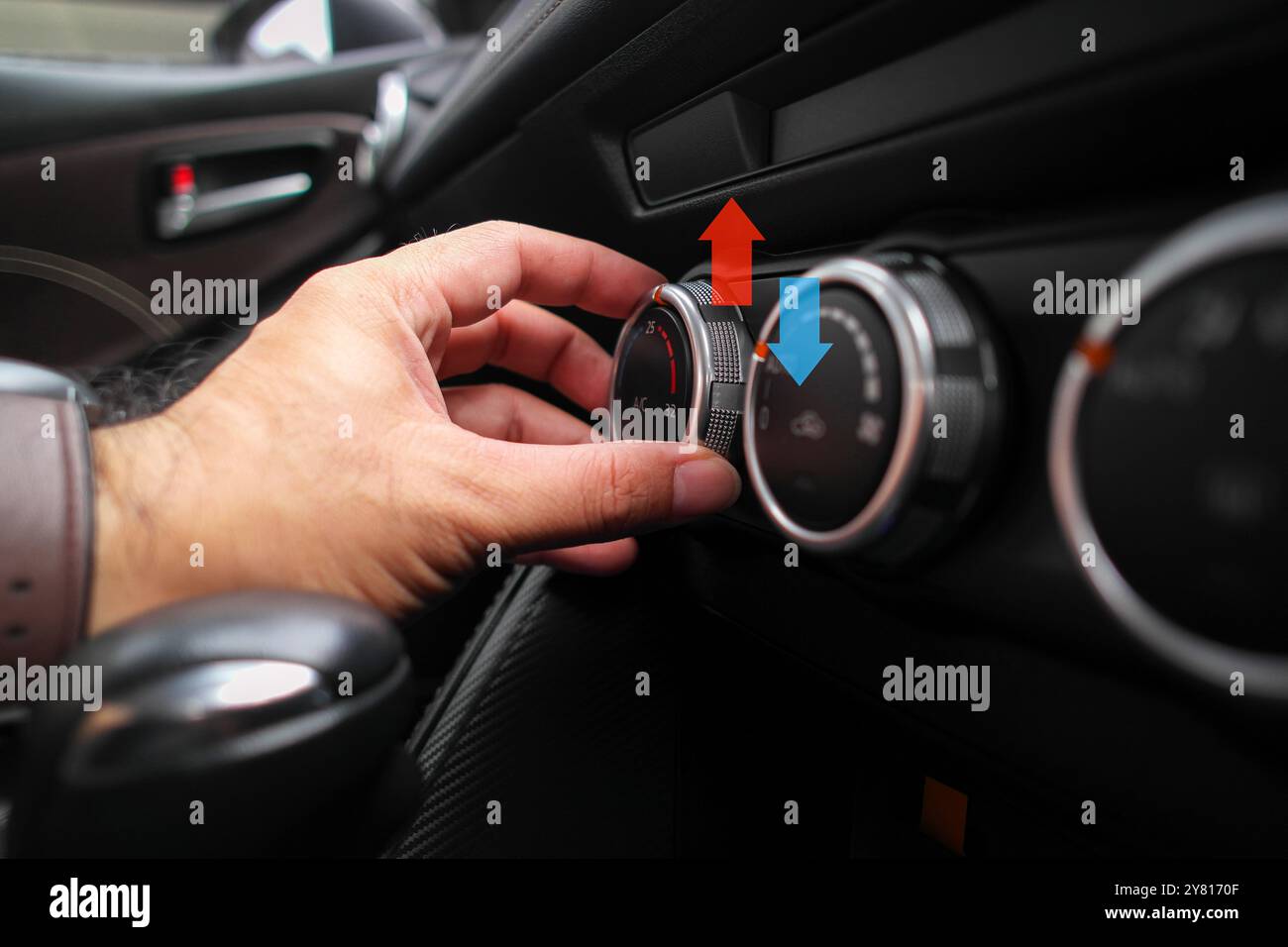 Adjusting the temperature of air conditioning inside a car , The driver ...