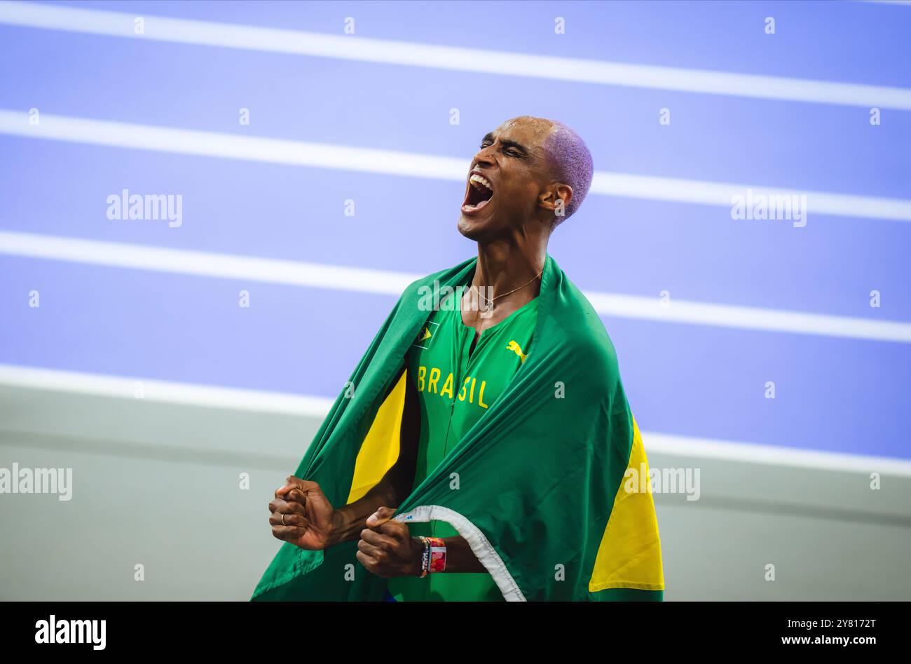 Alison dos Santos celebrating with her country's flag in the 400 meters ...