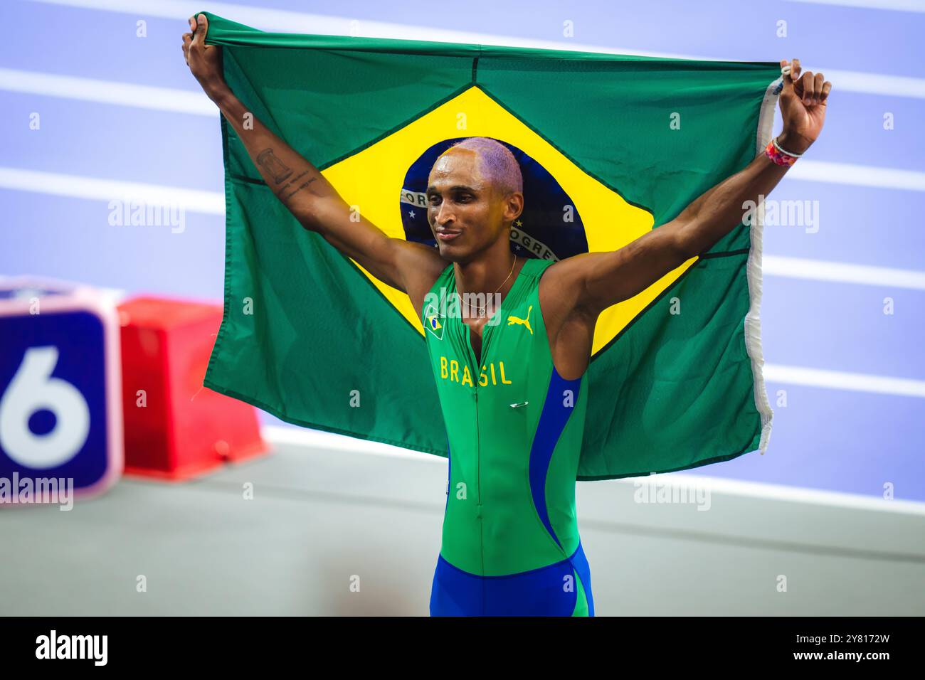 Alison dos Santos celebrating with her country's flag in the 400 meters ...