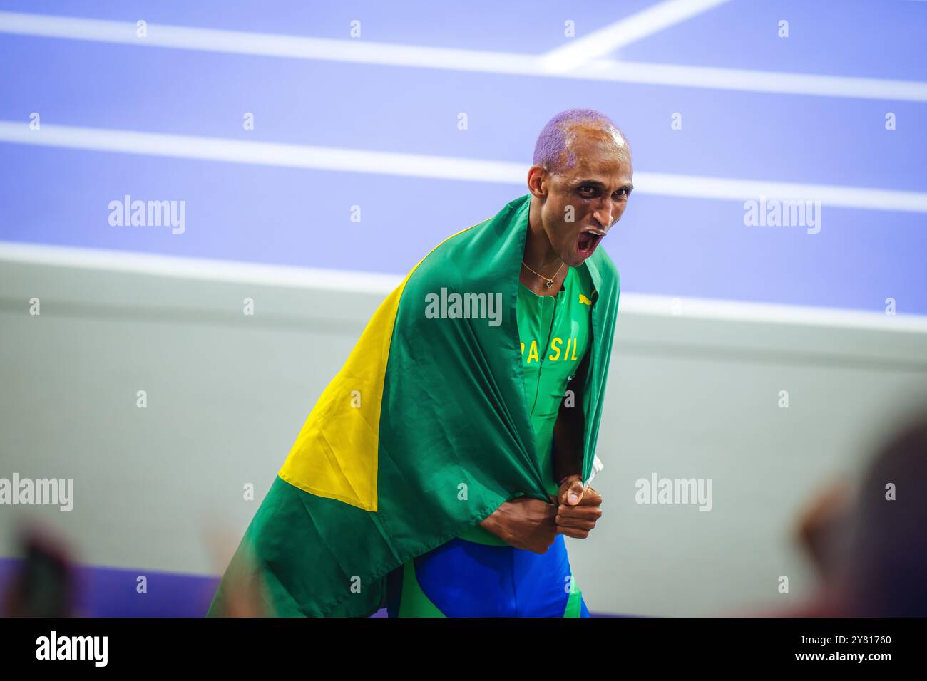 Alison dos Santos celebrating with her country's flag in the 400 meters ...