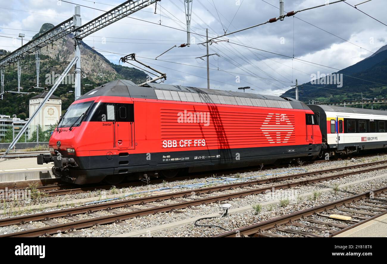 SBB Class Re 460 electric loco heads passenger train at Brig station ...