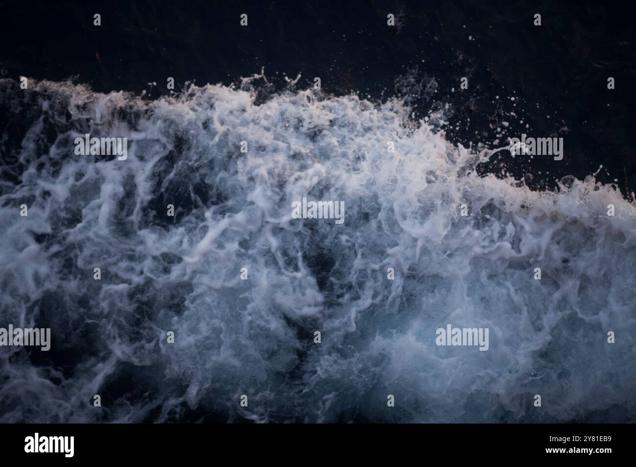 Deep blue stormy sea water surface with white foam and waves pattern ...