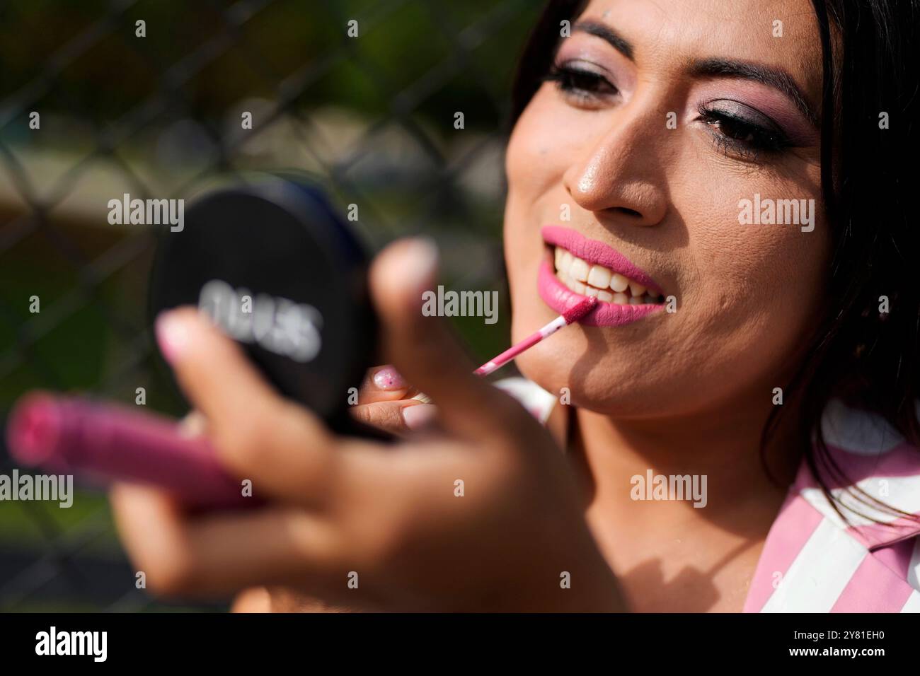 Julieth Luna Garcia, a transgender woman from El Salvador, looks into a ...