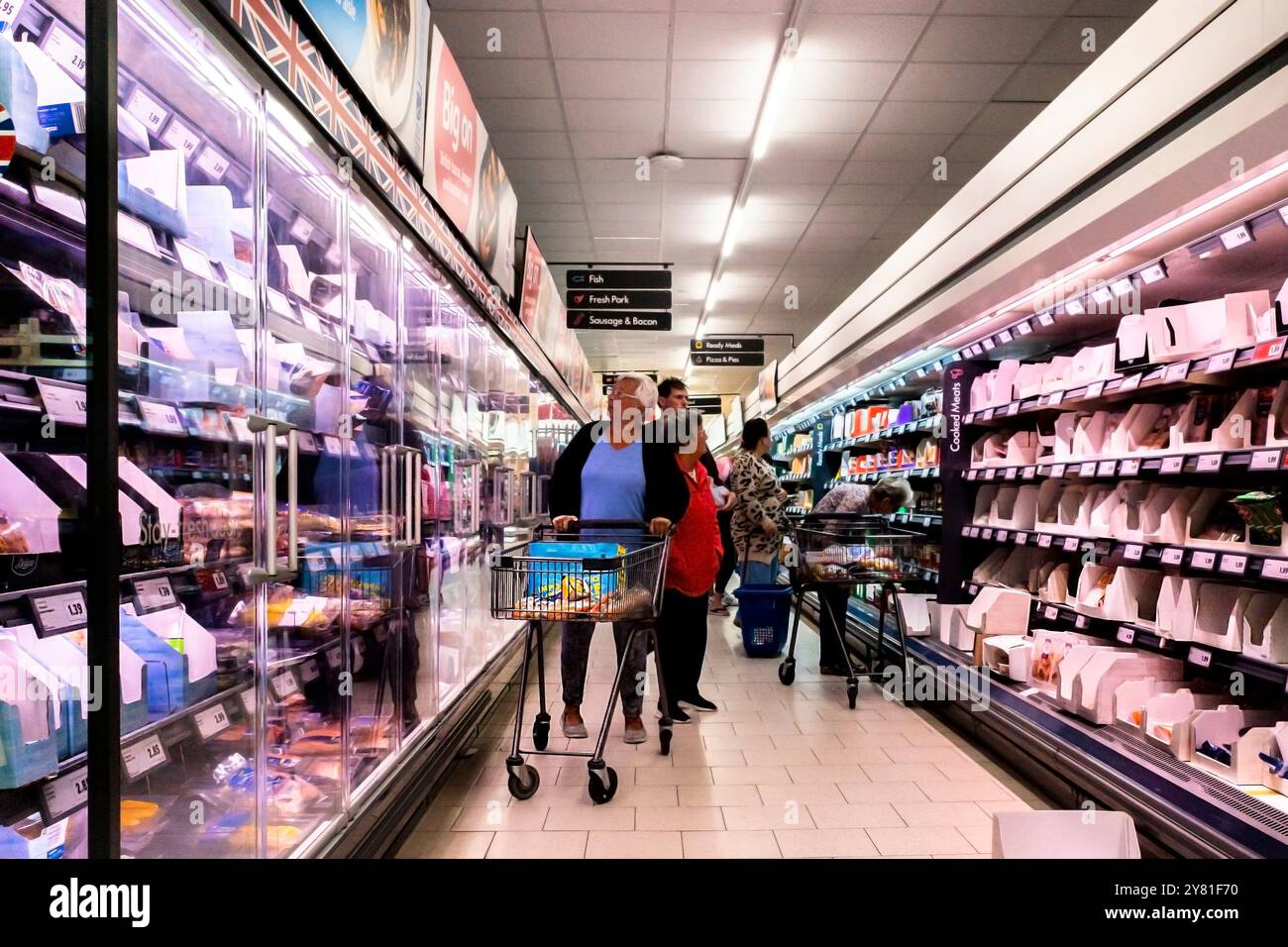Shoppers people customers shopping inside a Lidl shop store in England ...