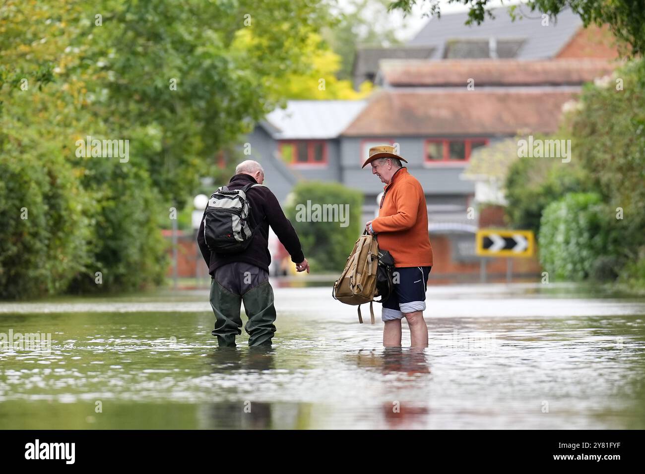 Residents stop to chat as they make their way to and from their ...