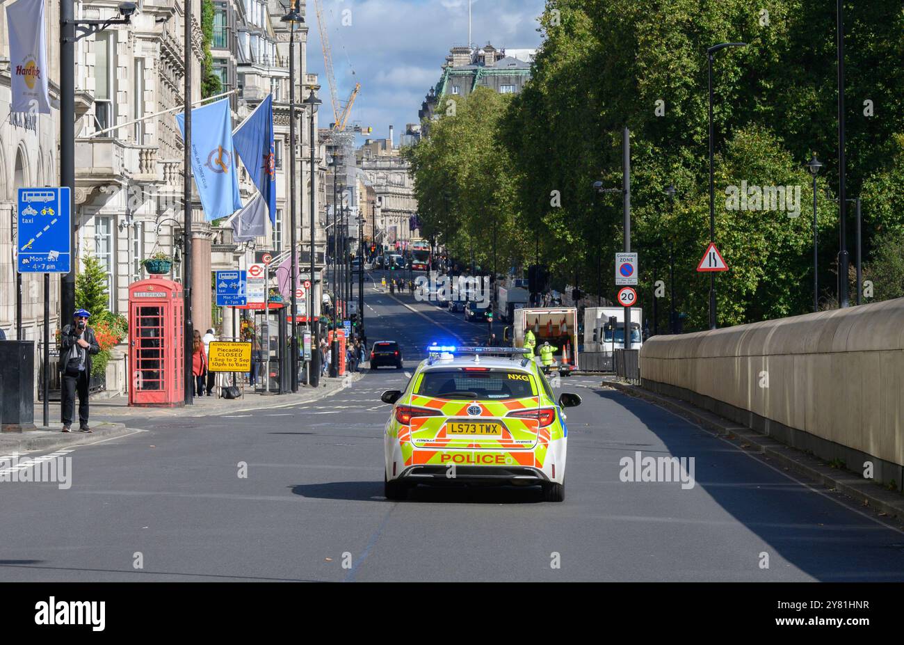 London, UK. Police car in Piccadilly driving ahead of a protest march ...