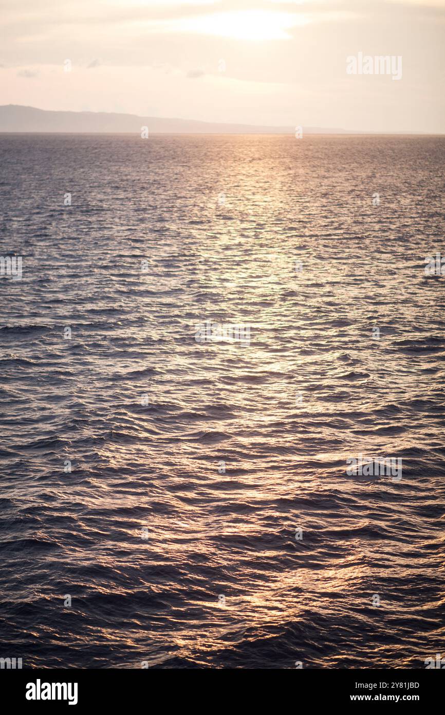 Sunrise light shining on ocean wave Stock Photo - Alamy