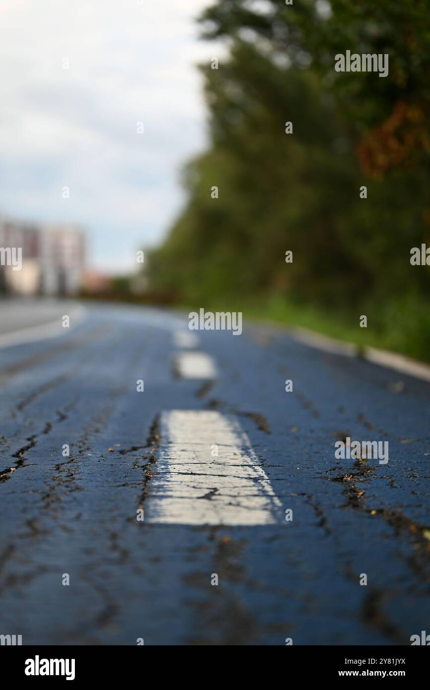 Perspective view of a blue bike lane with worn markings Stock Photo - Alamy
