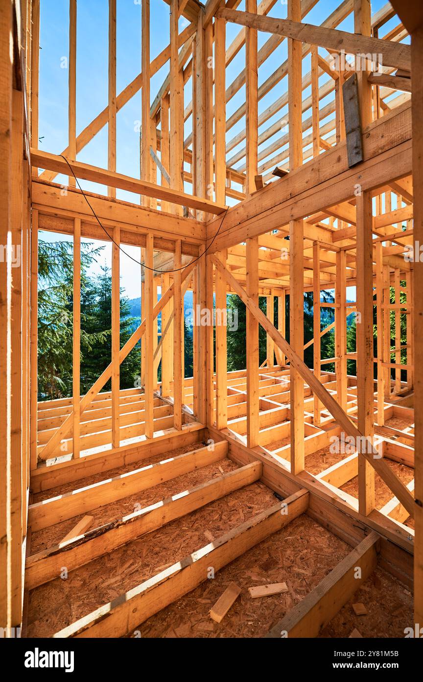 Under-construction residential wooden frame home located near a forest ...