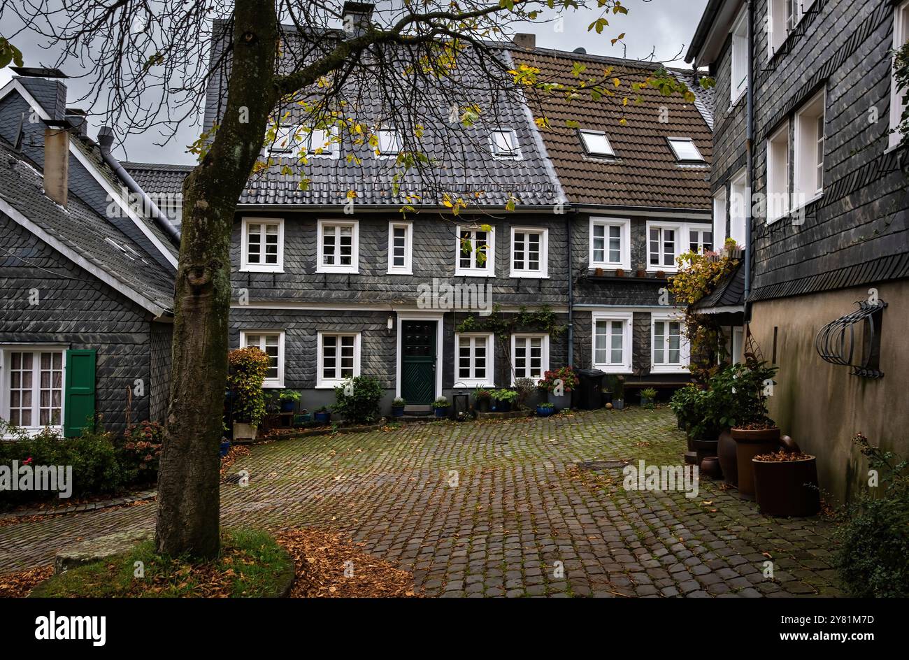 Cozy street with paving stones and slate houses in beautiful ...