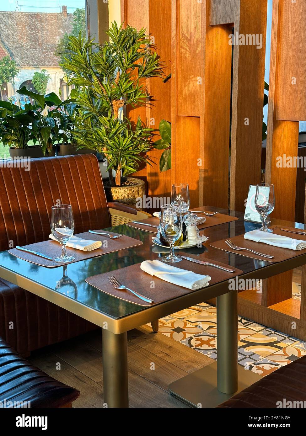 Cozy restaurant interior with elegantly set table, ready for guests ...