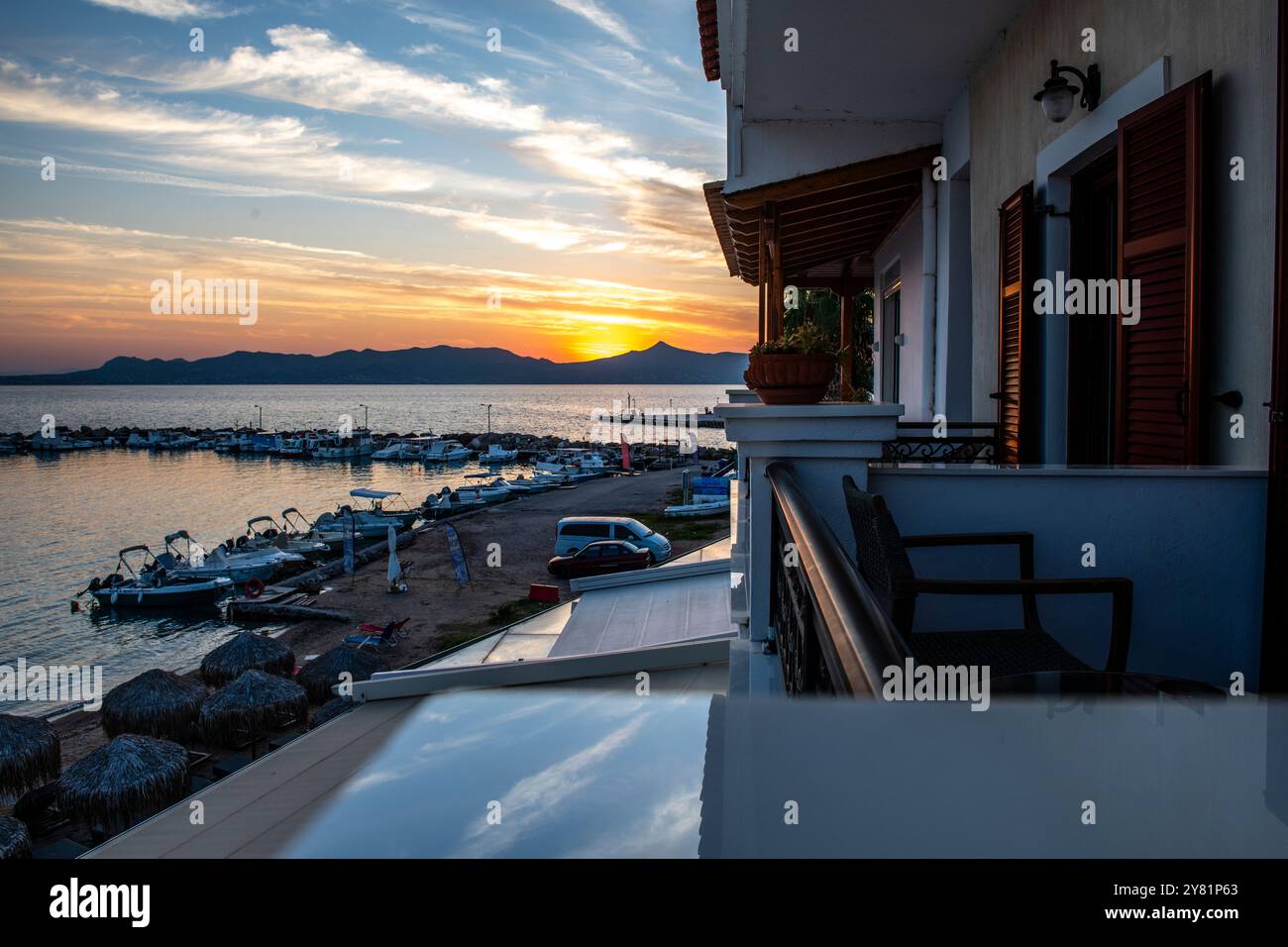 The dawn sunrise creating golden hour reflections on the hotel balcony ...