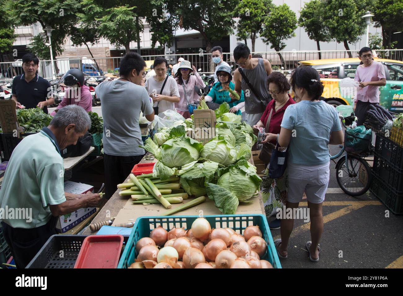 Residents buy vegetables and fruits at a traditional market in Taipei ...