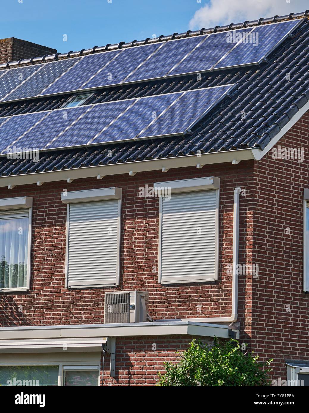 modern air-source heat pump unit mounted on the exterior wall of a ...