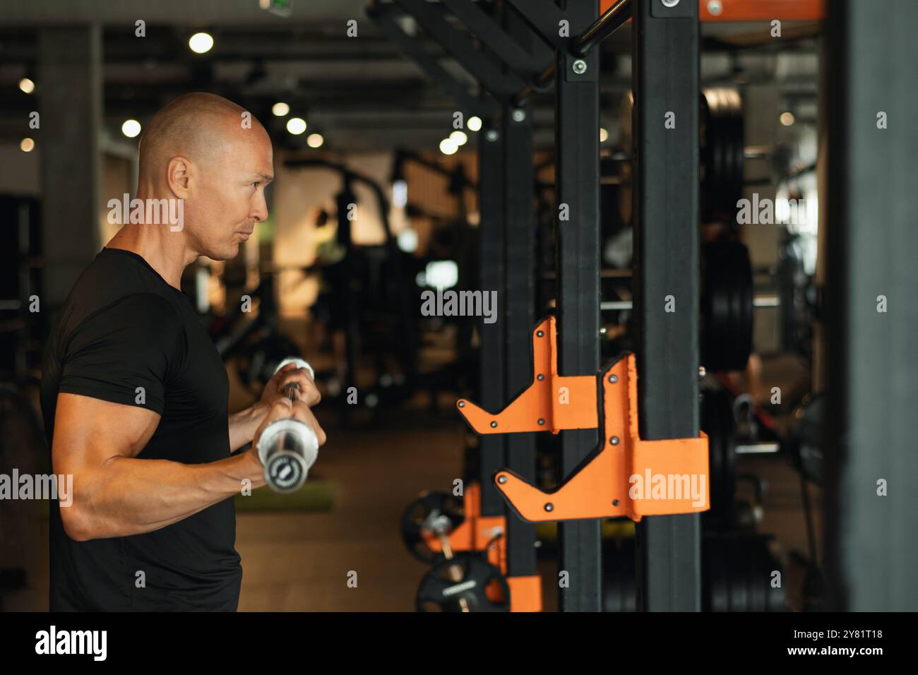 Athlete bodybuilder muscular man taking body bar from at gym. Working ...