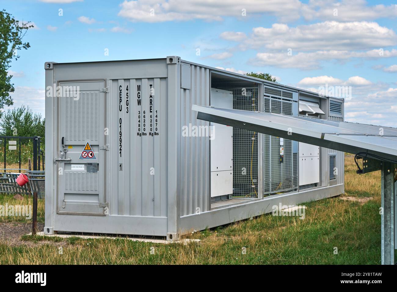 Mobile solar energy farm power inverter in a rural area with trees and ...