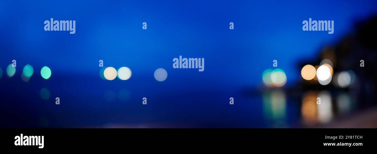 Defocused blur colorful lights of sea ocean beach in twilight ...