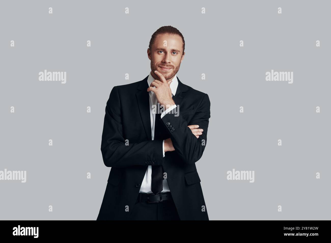 Looking into exciting future. Handsome young man in full suit looking ...