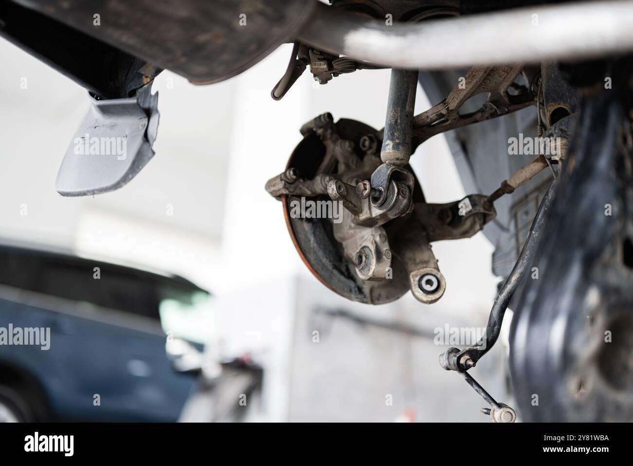Detailed view of a car's suspension system, showcasing mechanical parts ...