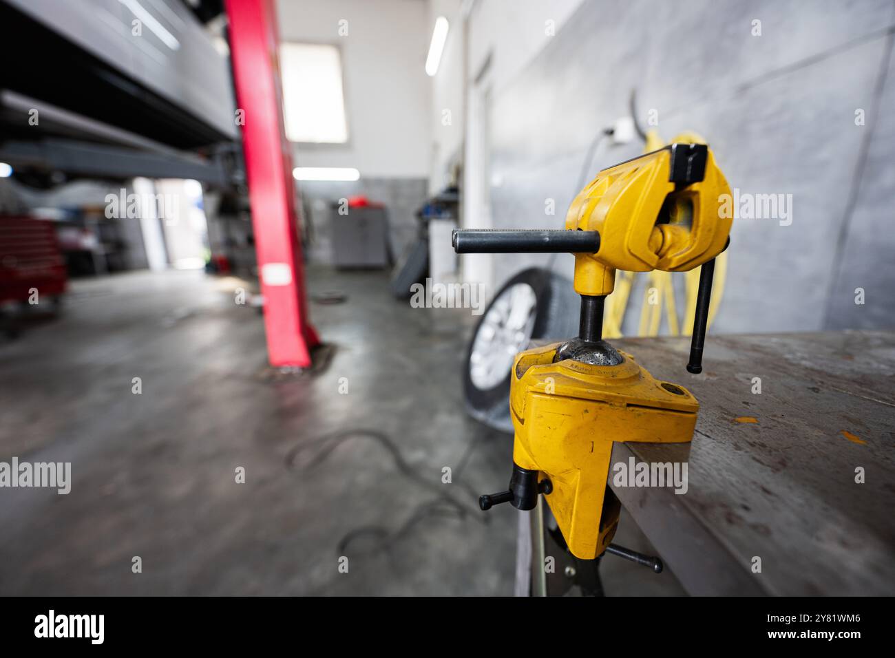 Interior of an automotive repair shop featuring a prominent yellow ...