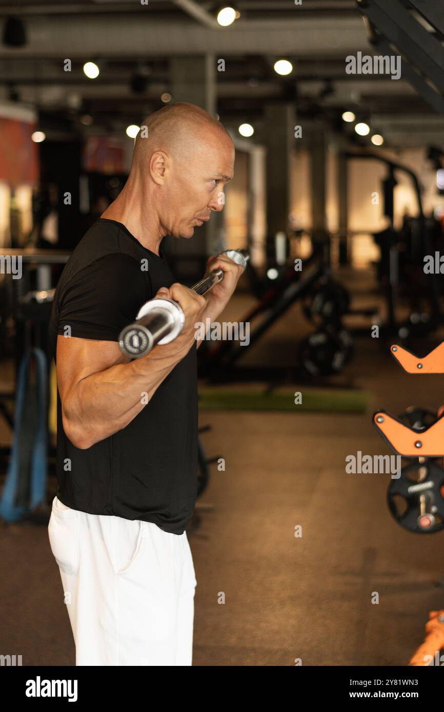 Athlete bodybuilder man make exercising with body bar for bicep from at ...