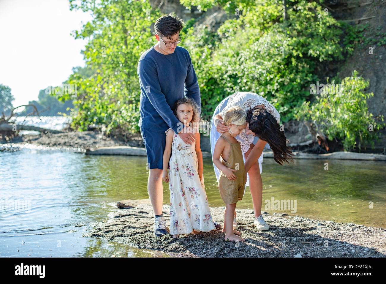 A family enjoys a day at the beach, mother speaks comforting words to ...