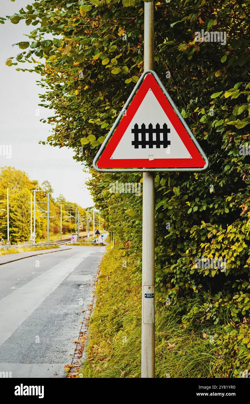 Railroad crossing traffic sign post on a roadside in Europe. Triangle ...