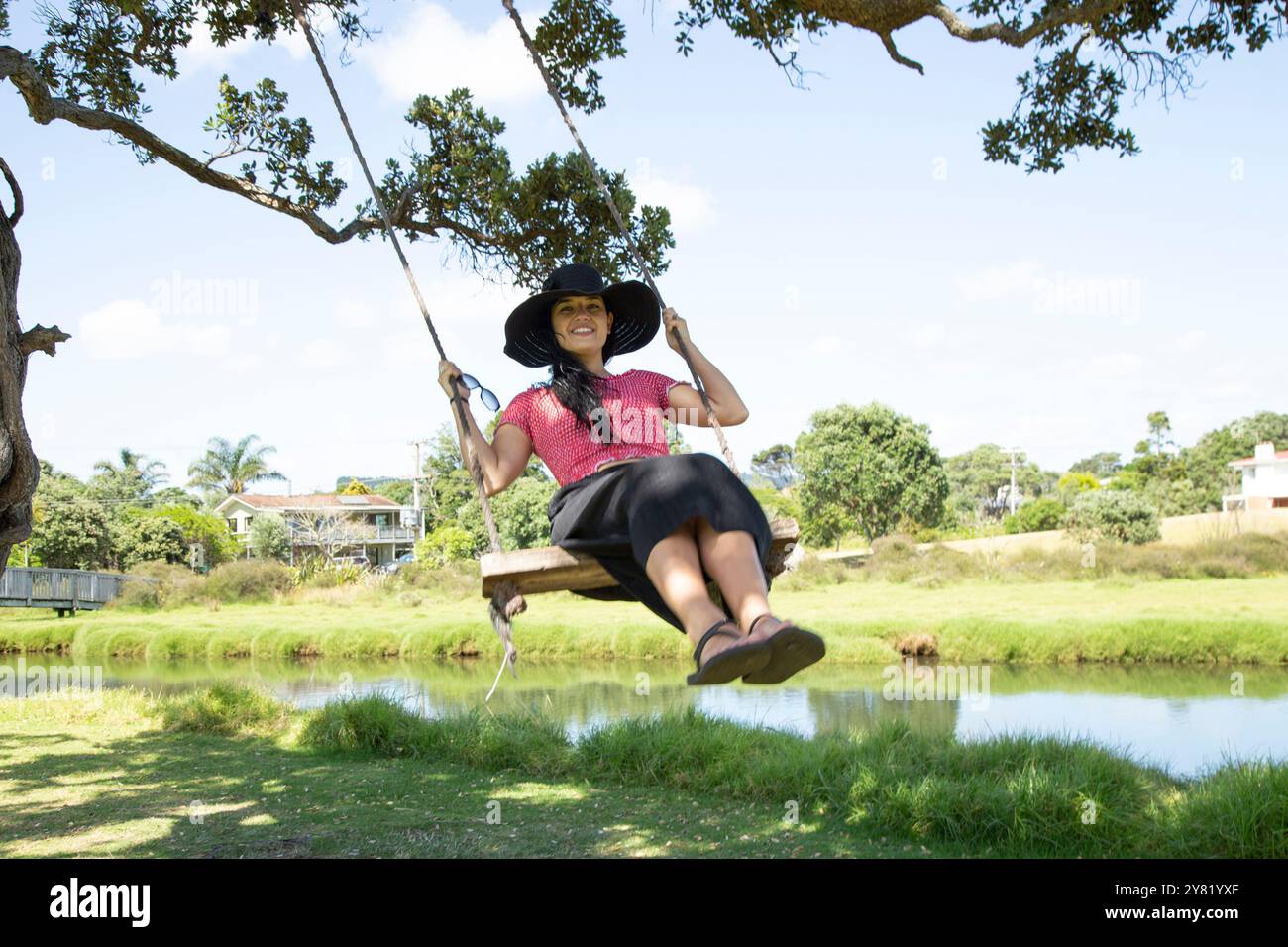 Woman on a swing and new zealand hi-res stock photography and images ...